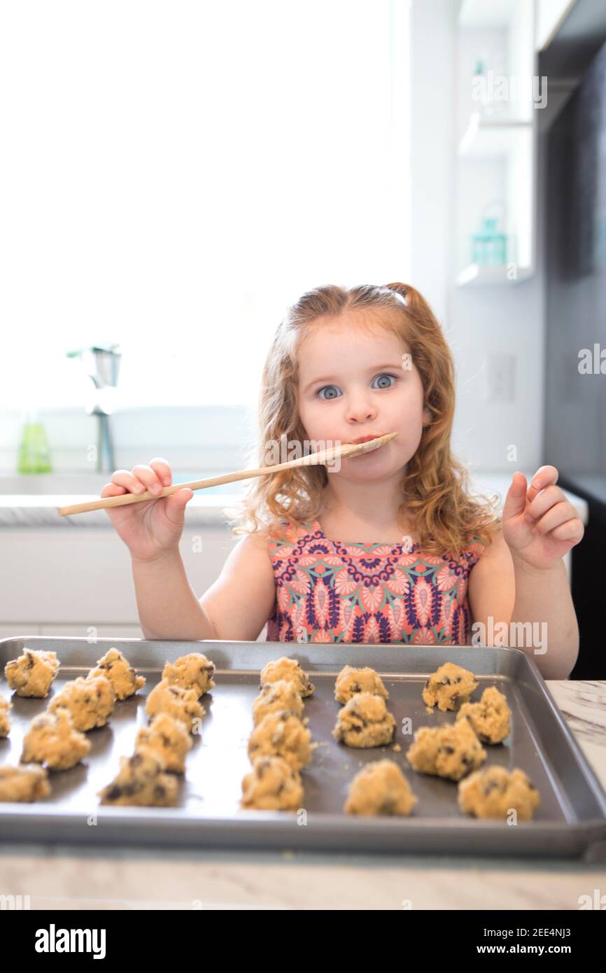 Child licking spoon hi-res stock photography and images - Alamy