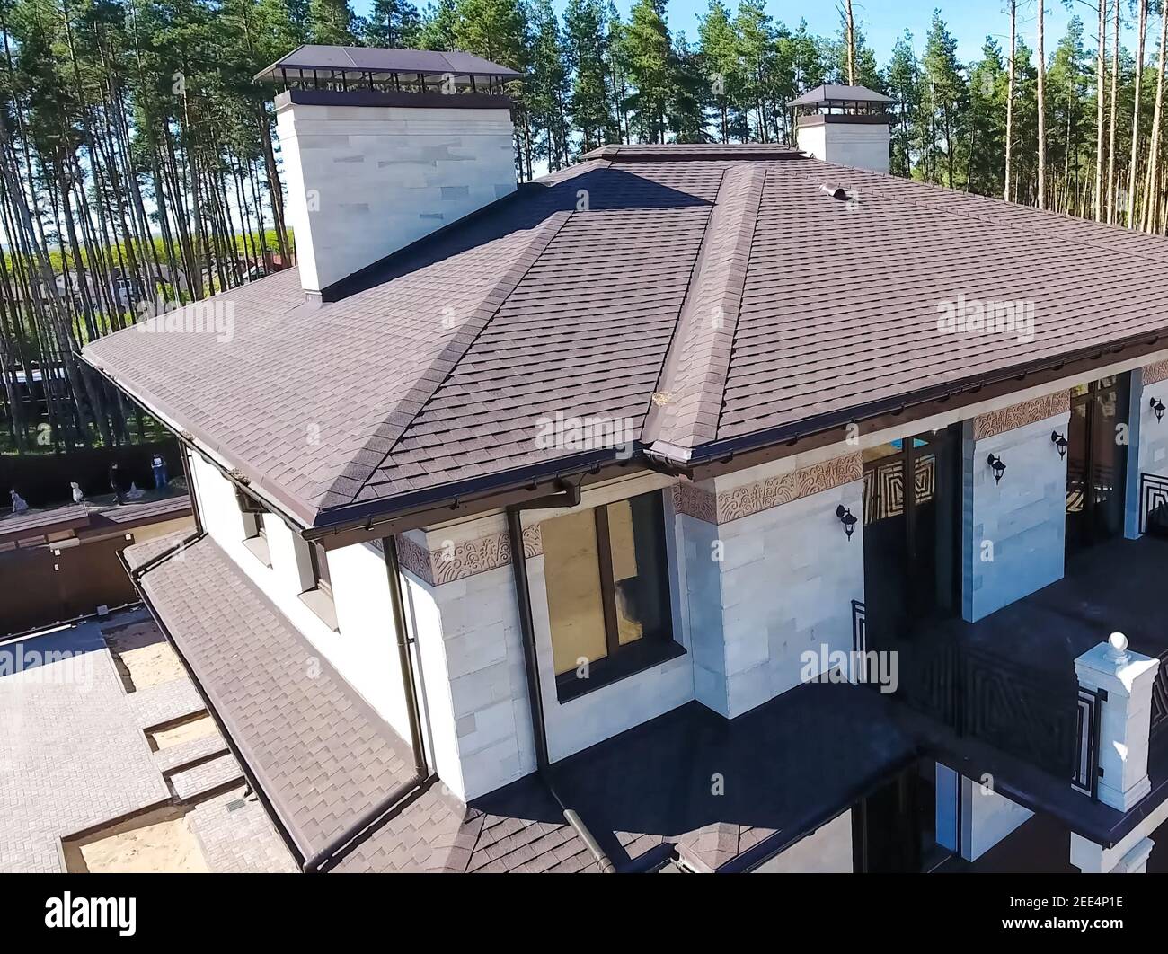 House with a roof from a bituminous tile. Bituminous tile for a roof. a ...