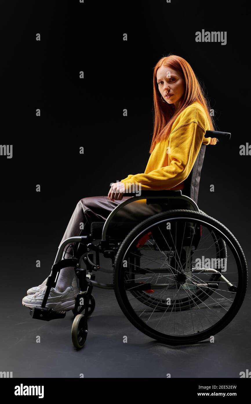 sad disabled woman in a wheelchair, looking at camera depressed ...