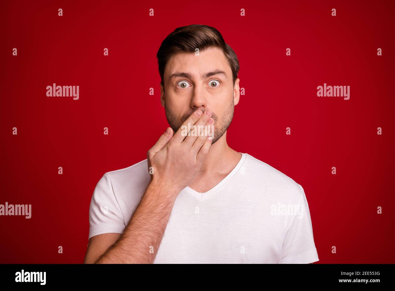 Photo portrait of shocked surprised guy keeping secret closed mouth ...