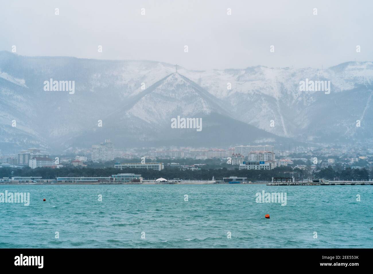 Gelendzhik city in winter in snowy weather, mountains covered with snow ...