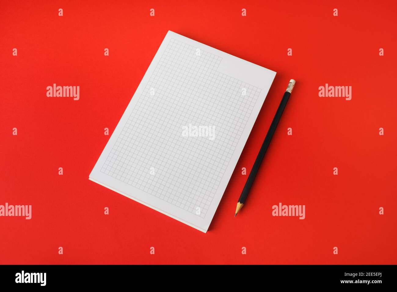 Blank stationery mockup. Blank copybook and pencil on red paper ...