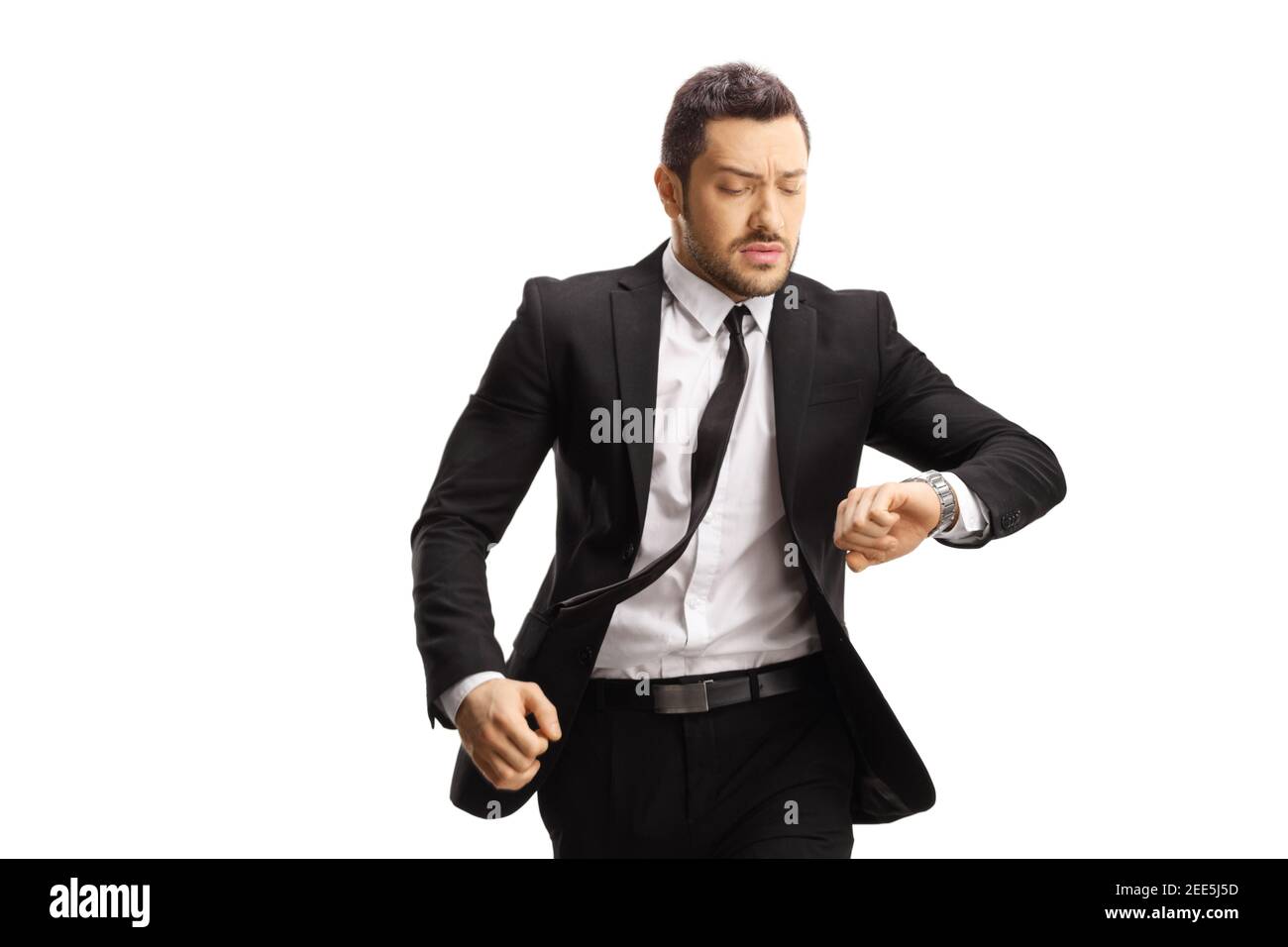 Serious young businessman running late isolated on white background ...