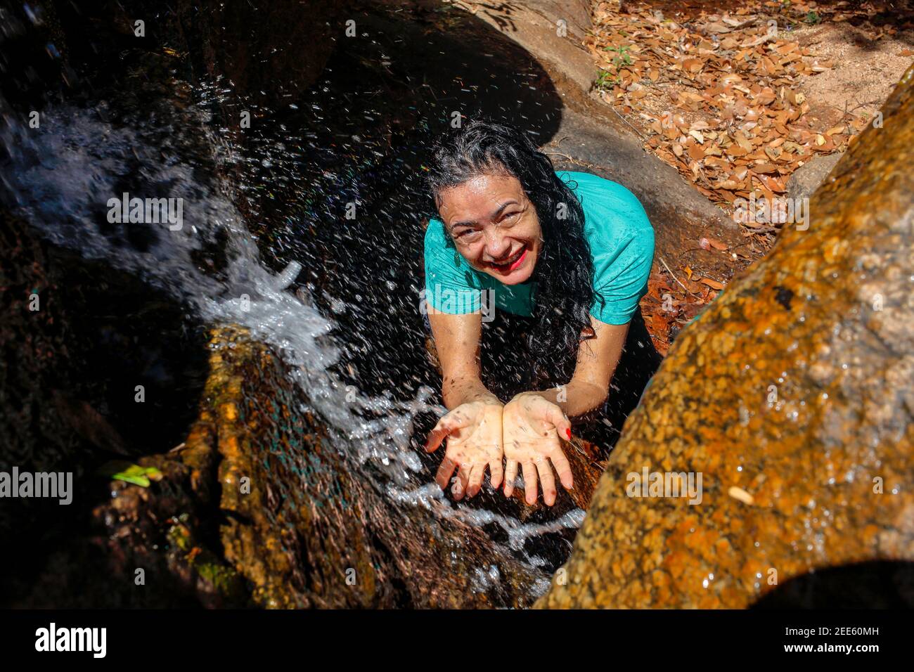 Woman drinking water in a crystal clear stream Stock Photo - Alamy
