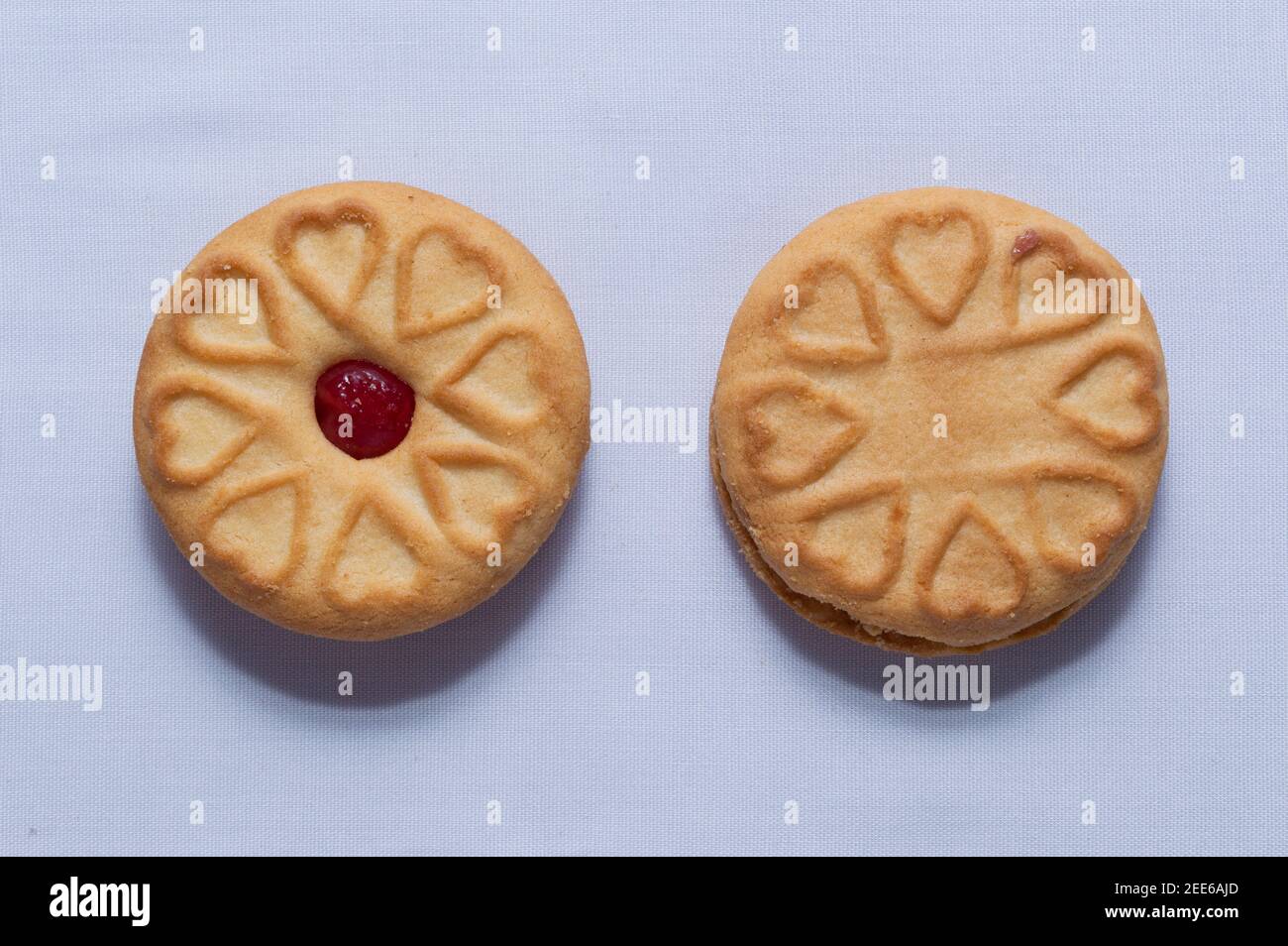 Red centered jam biscuits with a strawberry flavor on a plain white ...