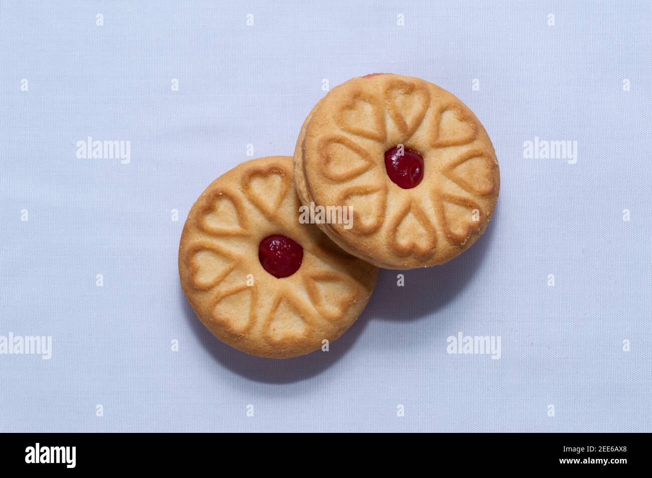 Red centered jam biscuits with a strawberry flavor on a plain white ...