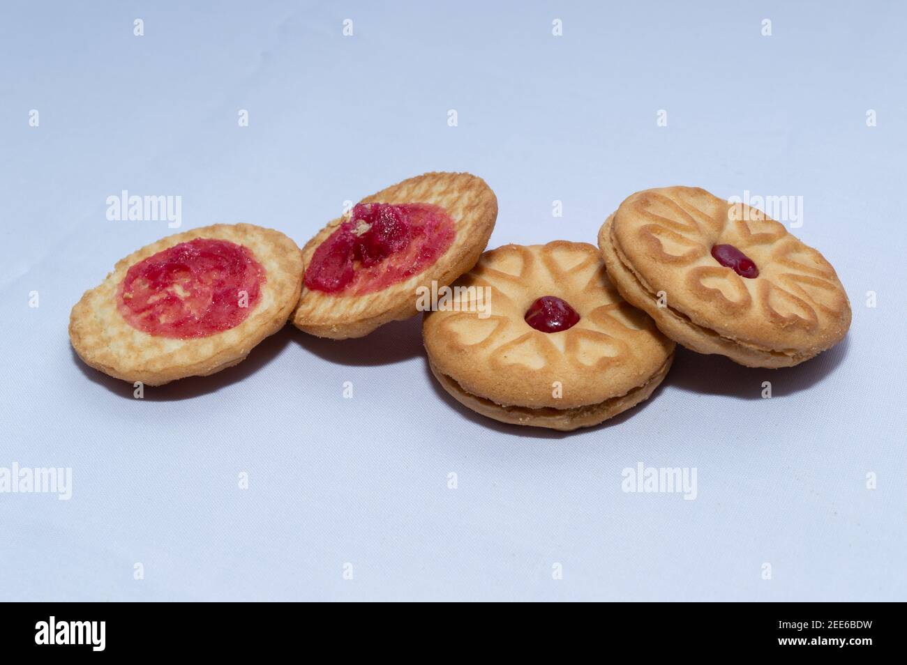 Red centered jam biscuits with a strawberry flavor on a plain white ...