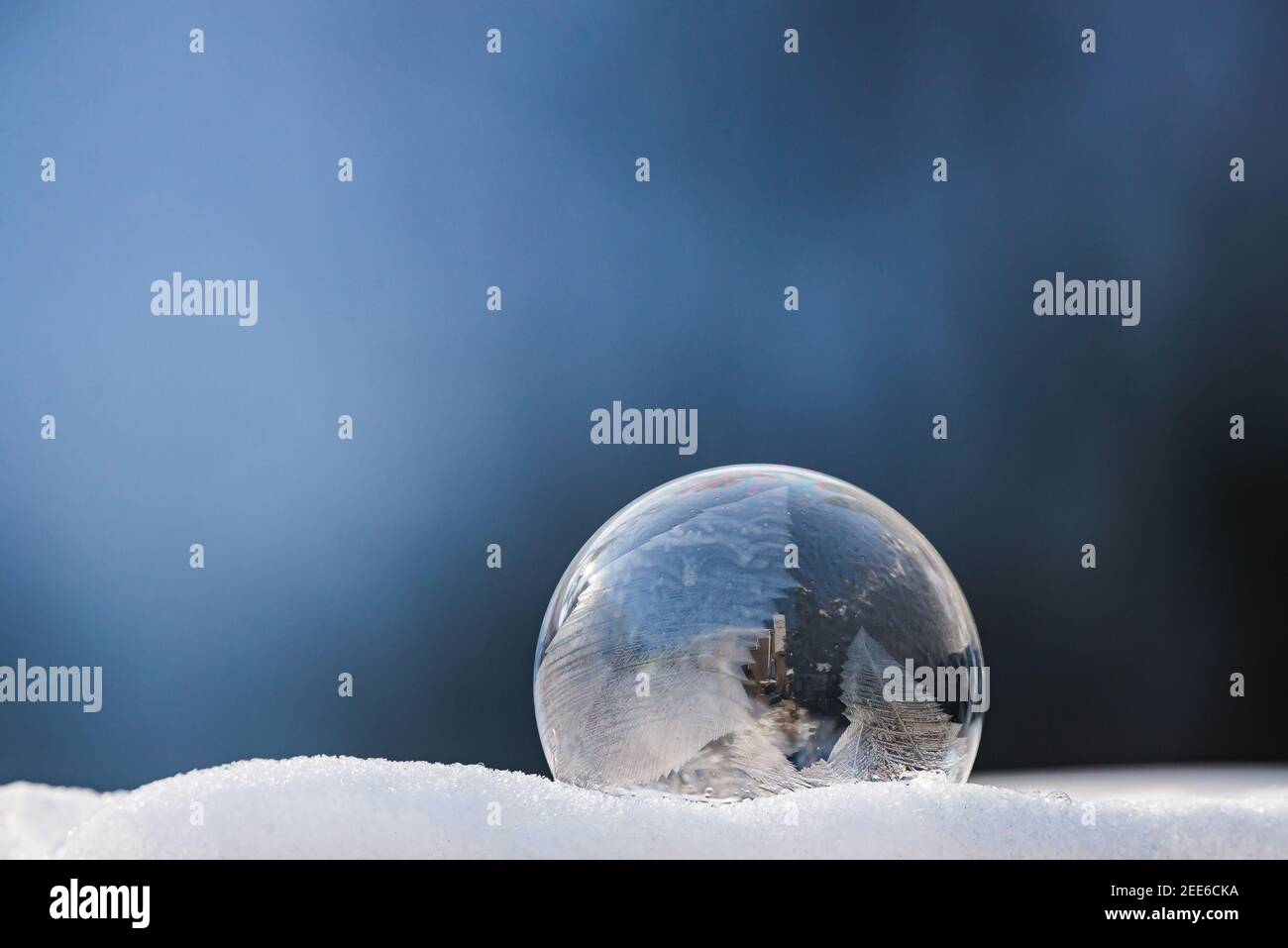 One frozen soap bubble on white snow with dark background Stock Photo ...