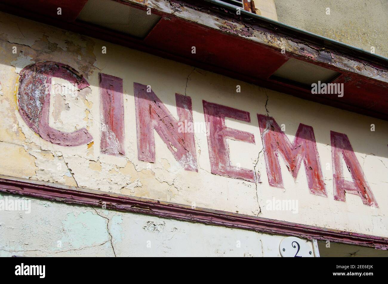 Old lettering "Cinema" on weathered house facade Stock Photo - Alamy