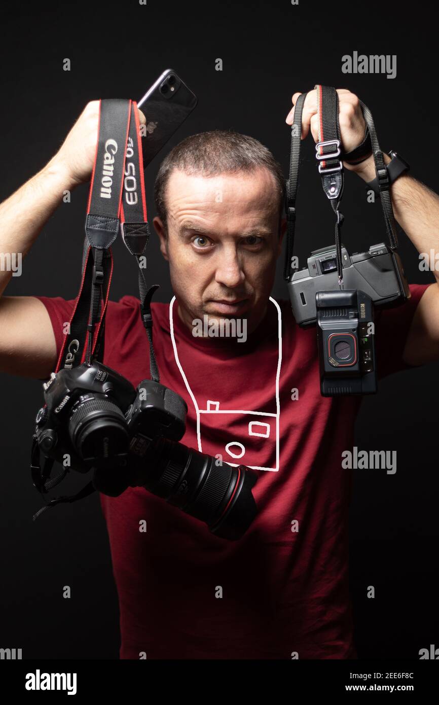 Man with many cameras Stock Photo - Alamy