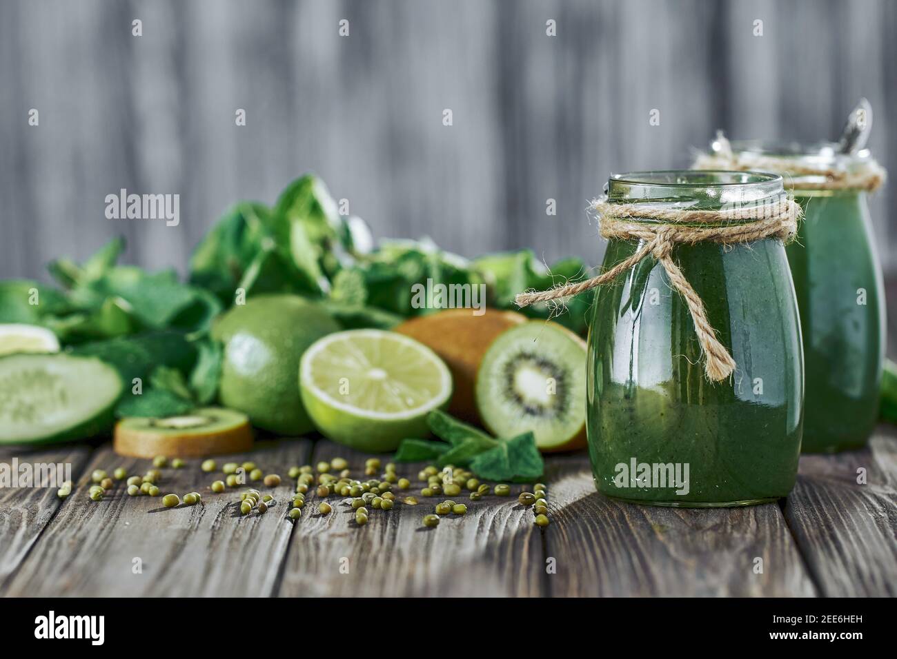 Blended green smoothie with ingredients on the stone board, wooden ...