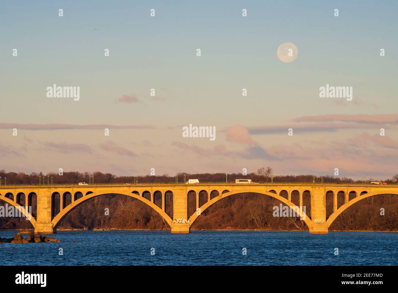 The full moon sets in the early morning light over Key Bridge in ...