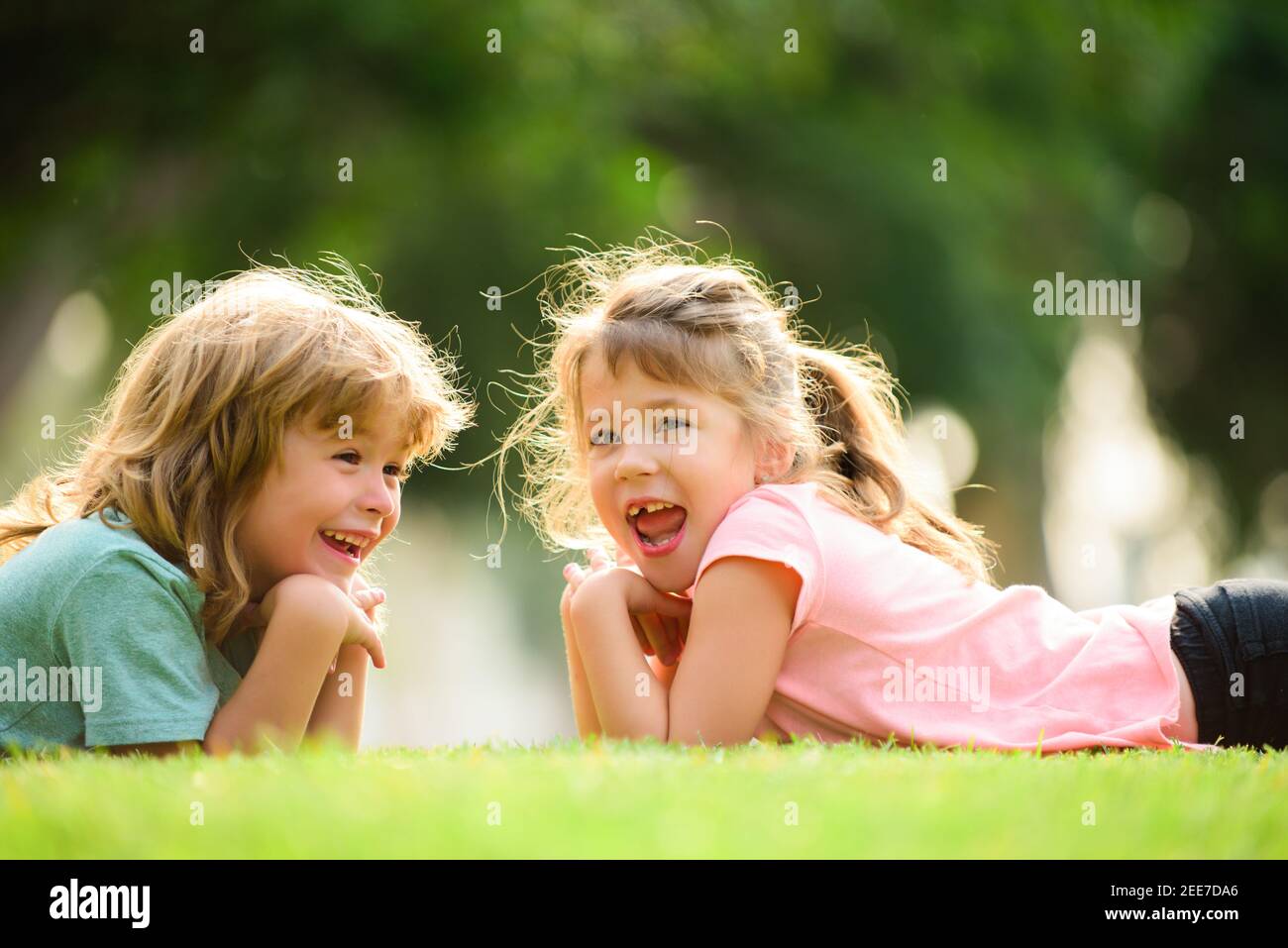 Cute kids couple in love. Two children on spring field. Adorable happy ...