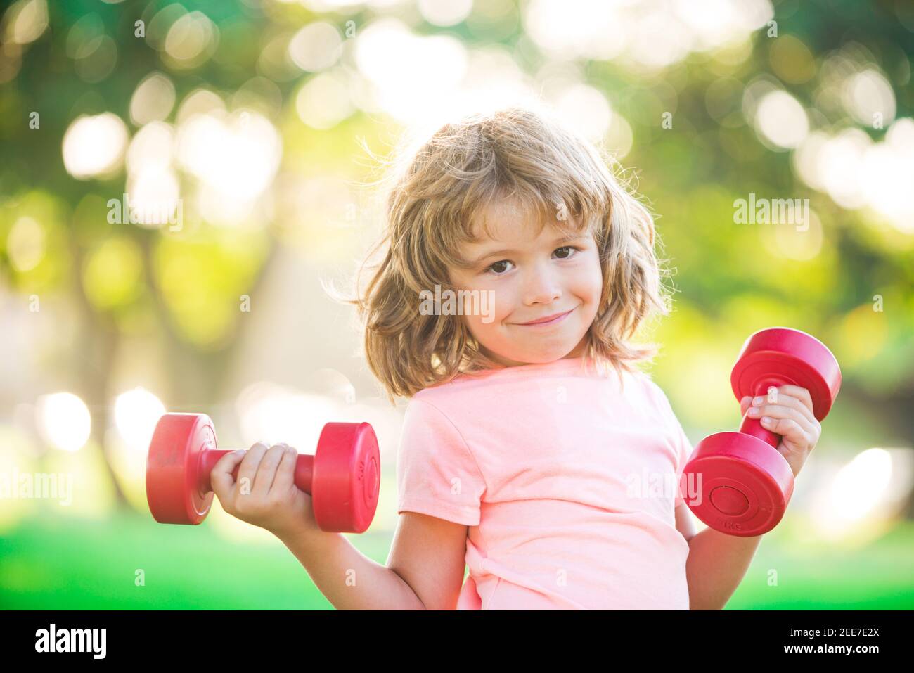 Kid workout. Child exercising with dumbbells. Sporty child with ...