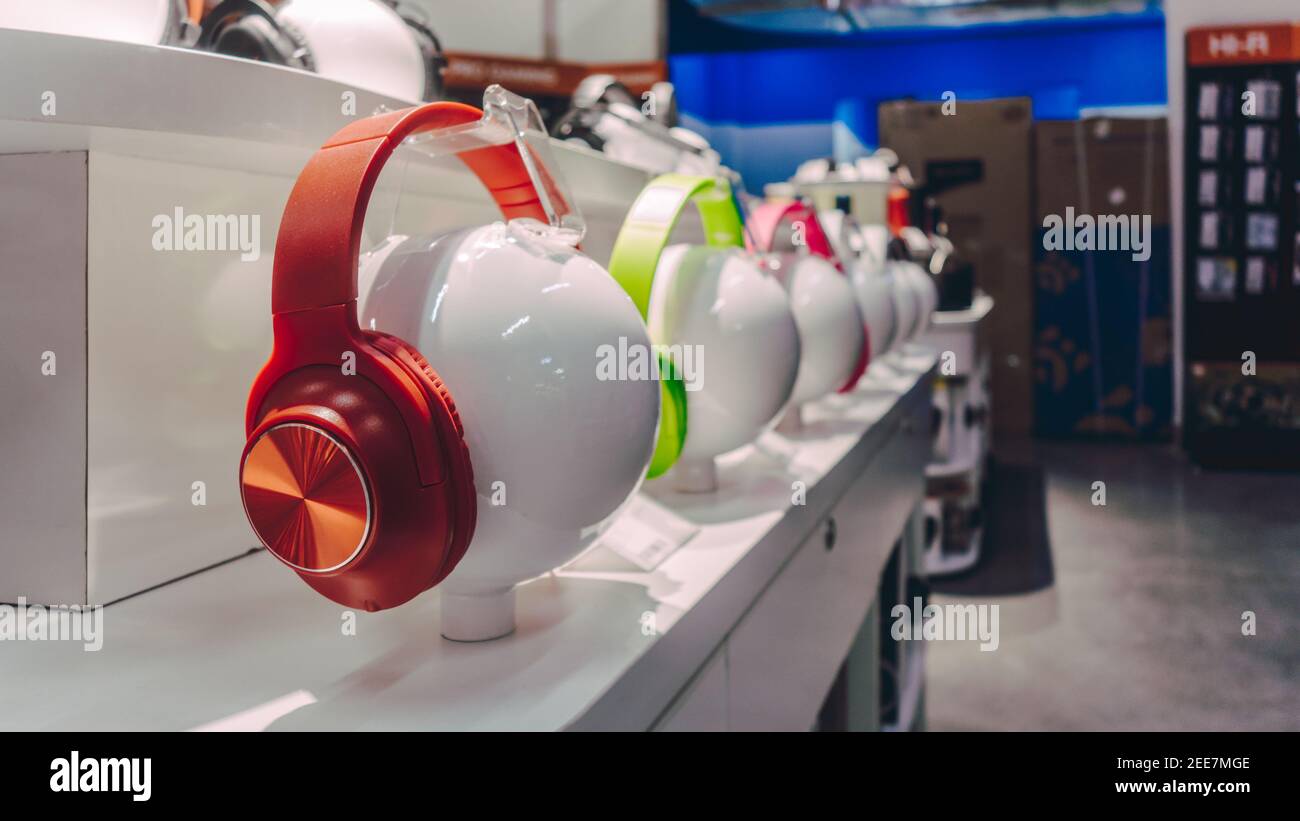 Colored headphones on mannequins,in the shop window of electronics and ...
