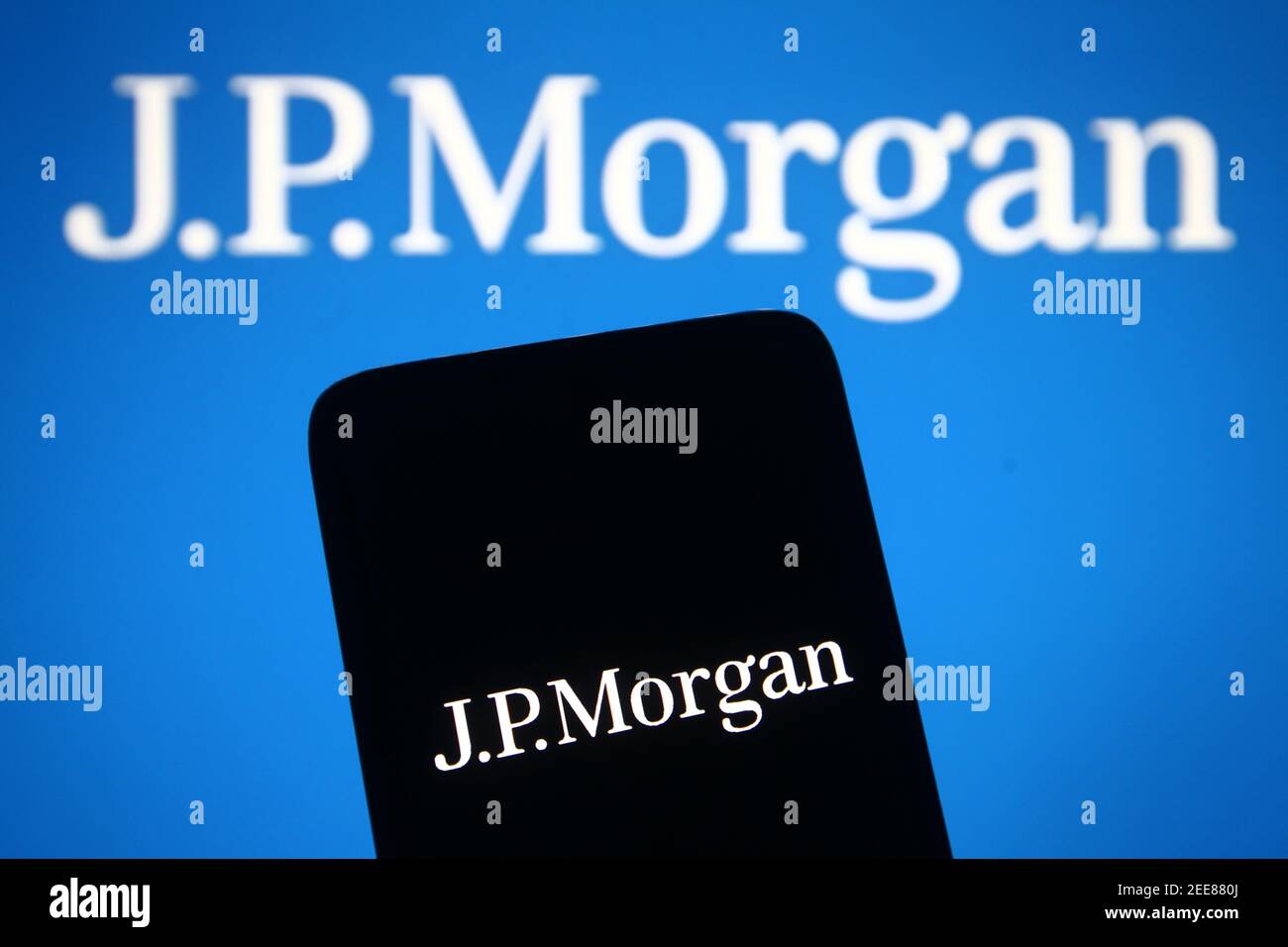 In this photo illustration, JPMorgan logo is seen on a smartphone and a pc screen Stock Photo ...