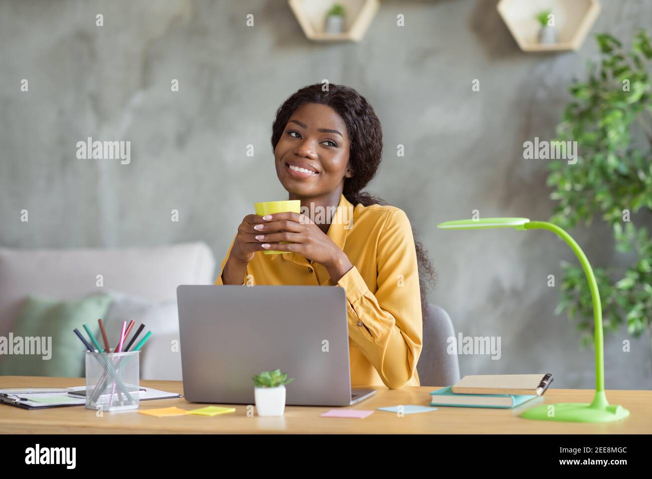 Photo of happy dreamy dark skin young business woman sit office desk ...