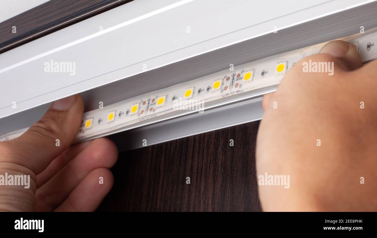 LED strip installation,installation of a diode tape Stock Photo - Alamy