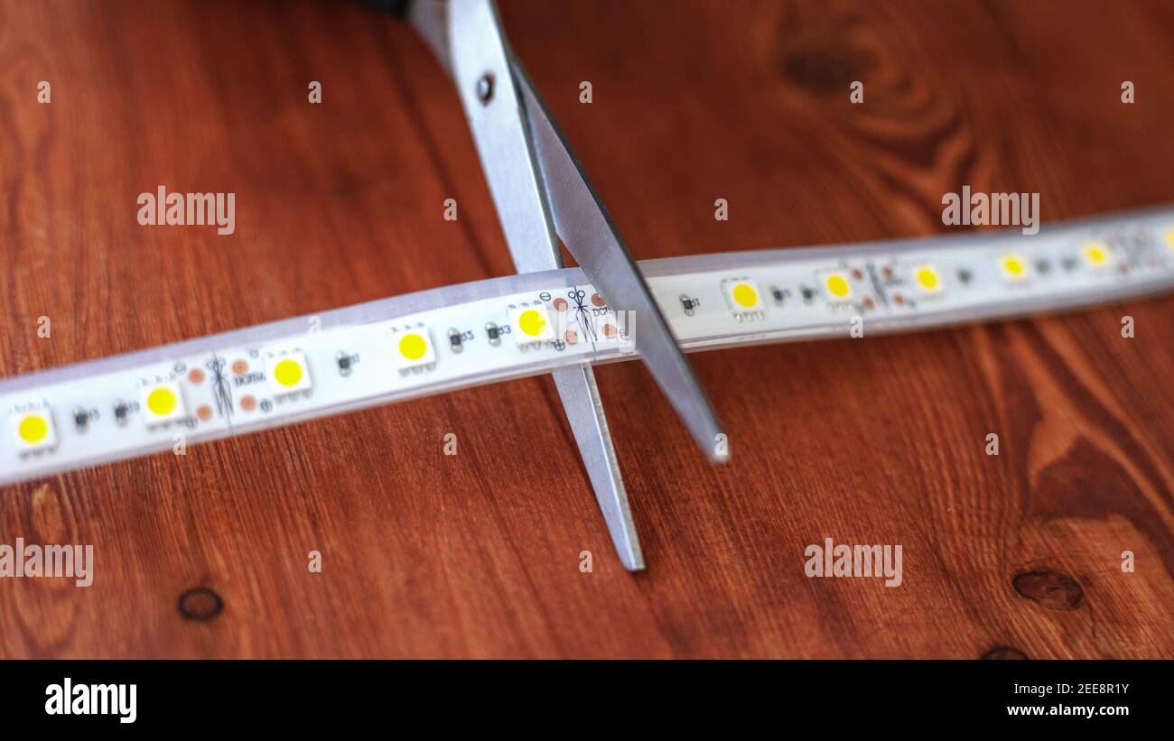 cutting the LED strip during installation closeup Stock Photo - Alamy