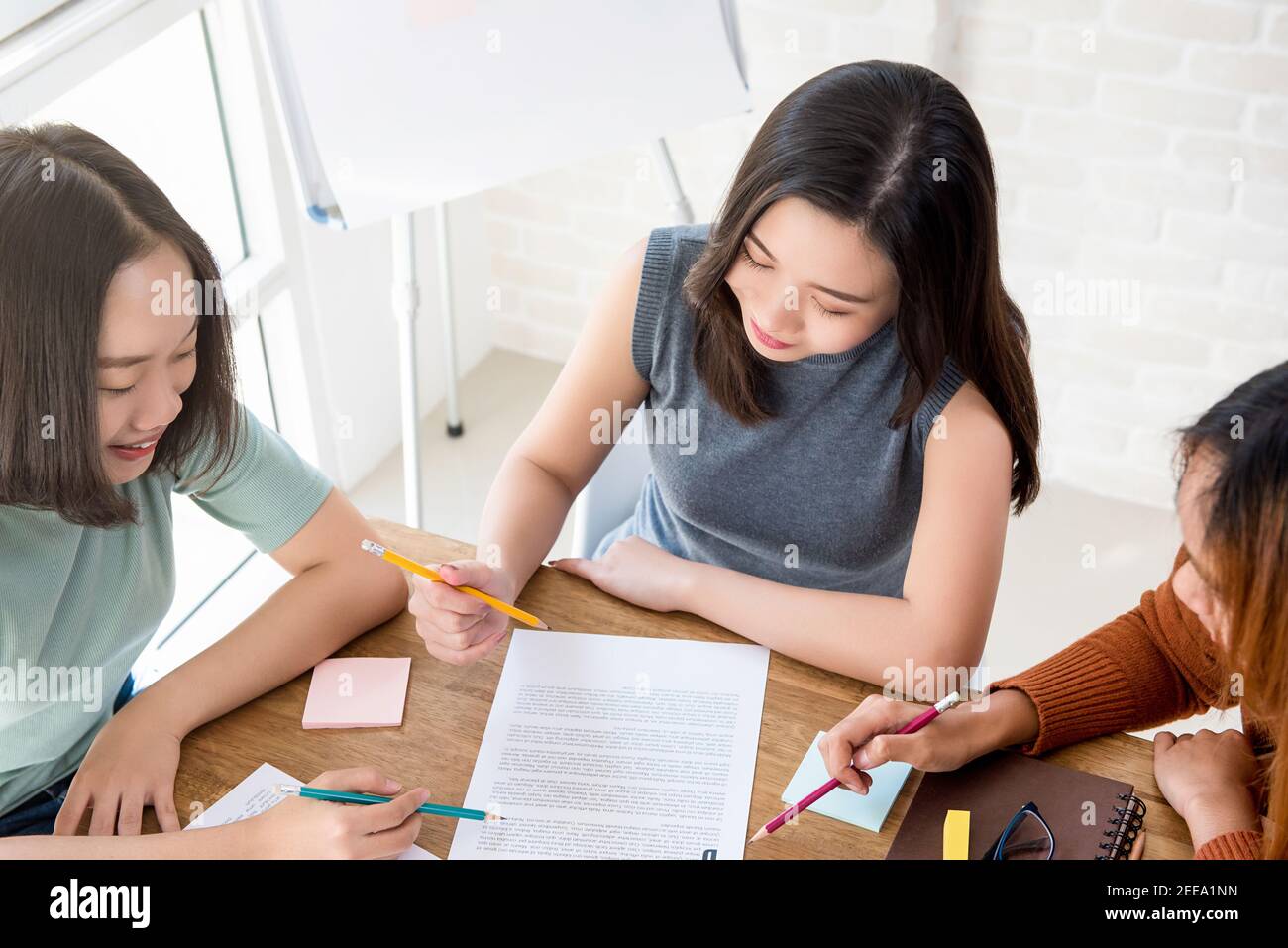 Group of oversea college Asian female students doing assignment at the ...