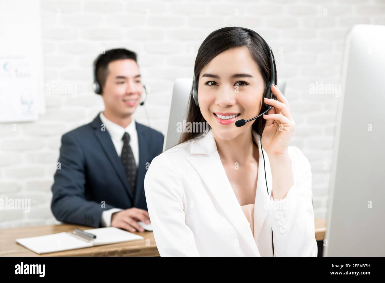 Smiling beautiful Asian woman telemarketing customer service agent ...