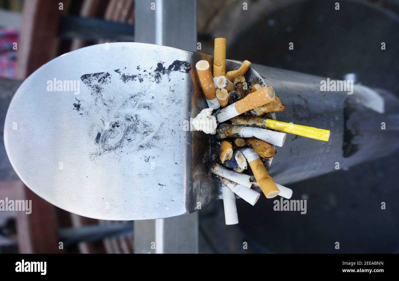 Full ashtray with butts and ash in street for public use Stock Photo ...