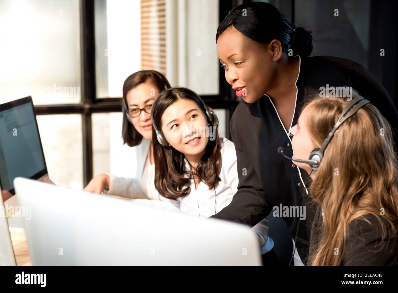Black female supervisor training work to her multiethnic colleagues in ...