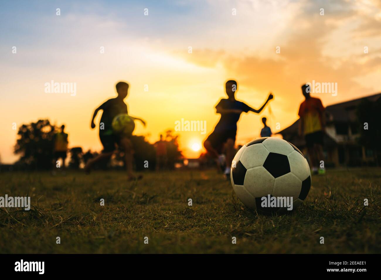 Silhouette of children playing football hi-res stock photography and ...