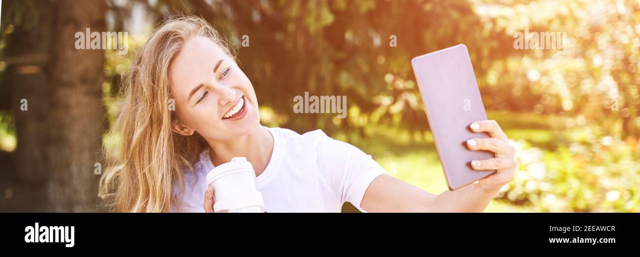 Young woman doing self portrait outside. Blogger selfie video Stock ...