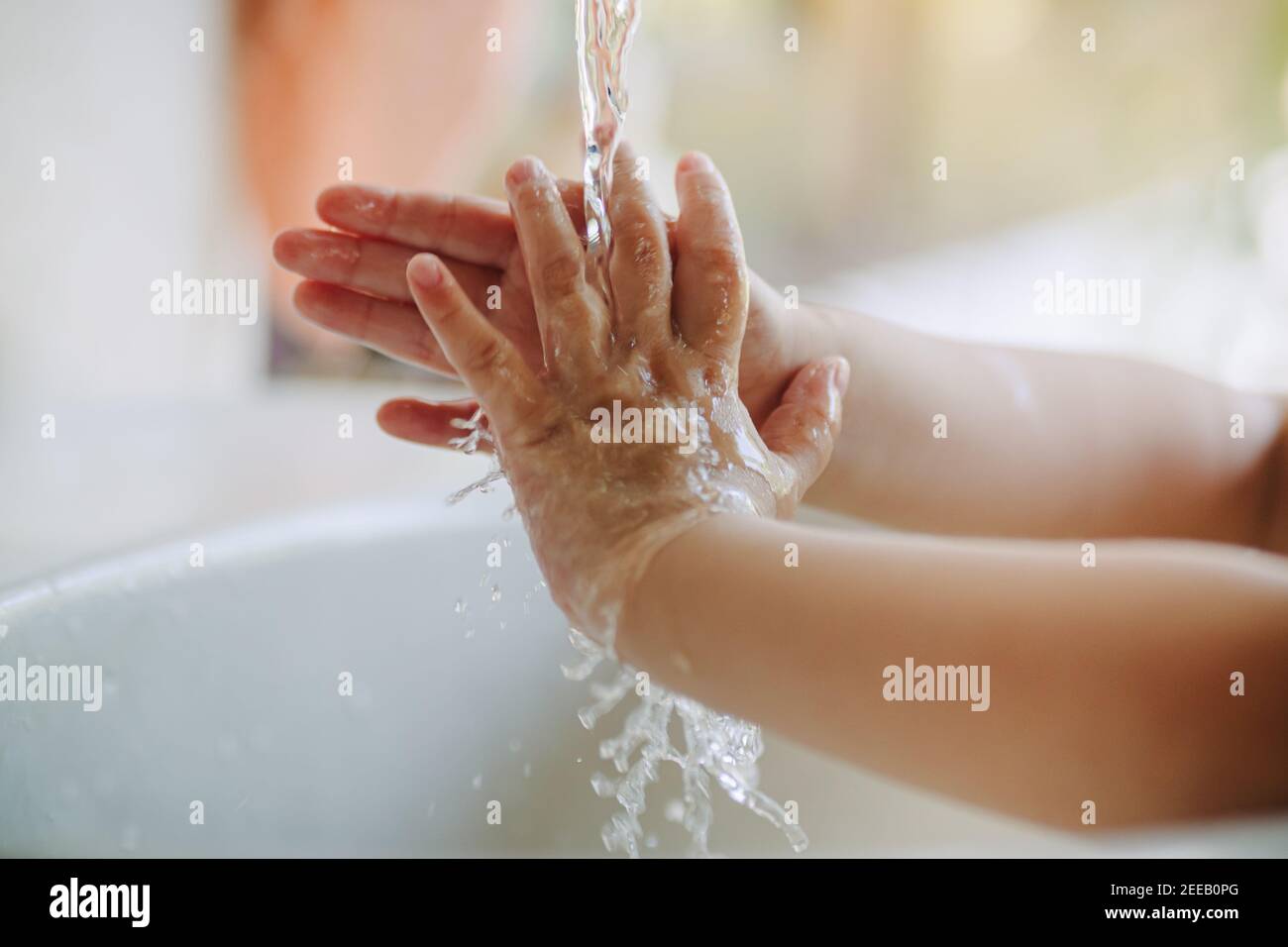 Kids washing hands with liquid soap and water for prevention from covid ...