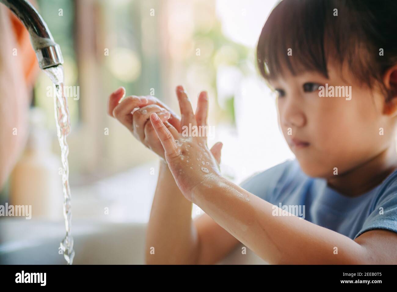 Kids washing hands with liquid soap and water for prevention from covid ...