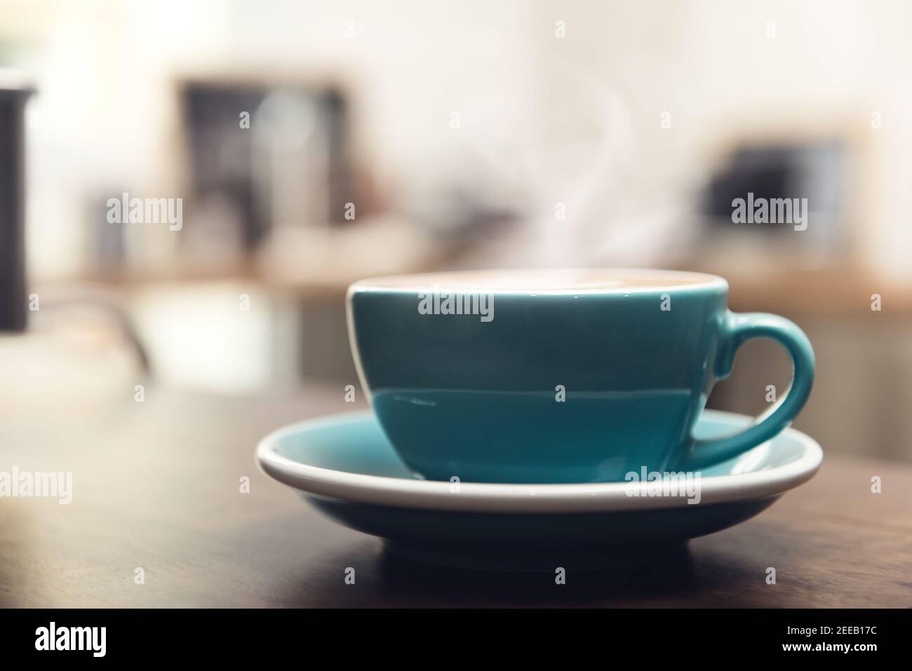 Hot fresh brewed coffee in blue turquoise cup on wood table ready to ...