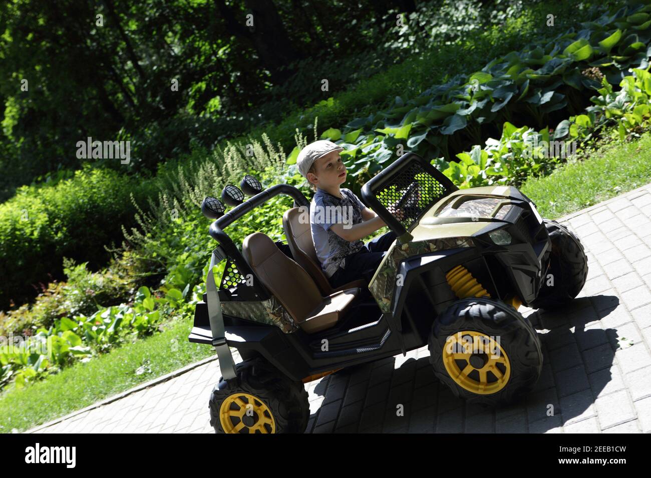 Boy driving a jeep in the park Stock Photo - Alamy