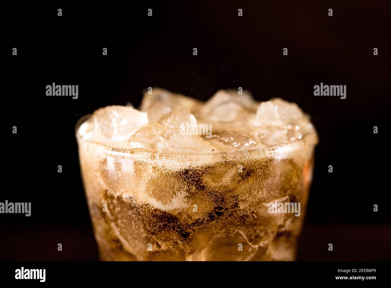 Close up of cold sparking cola sodar soft drink in the glass with foam ...