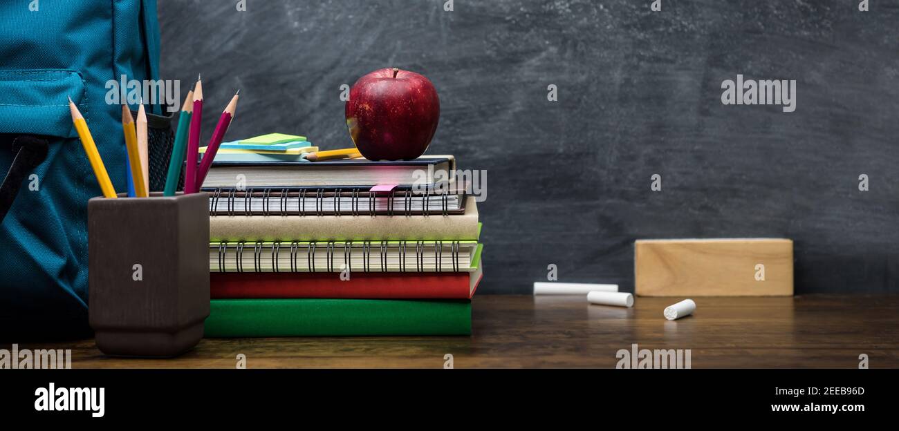 Stack of books, colorful stationery and education supplies on wooden ...