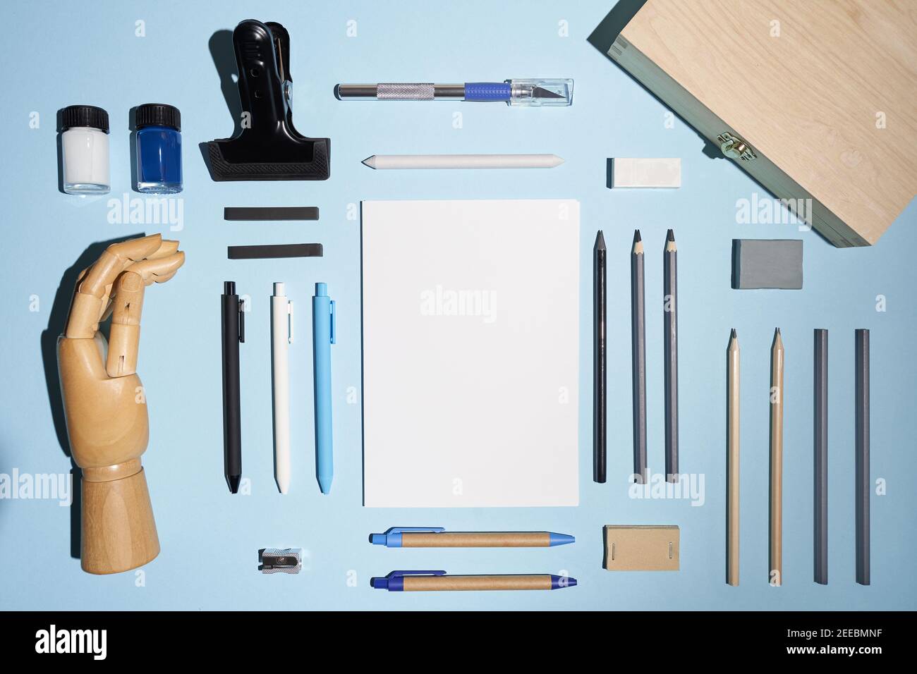 Flat lay notepad, pencils, pens and other drawing staff and wooden hand ...