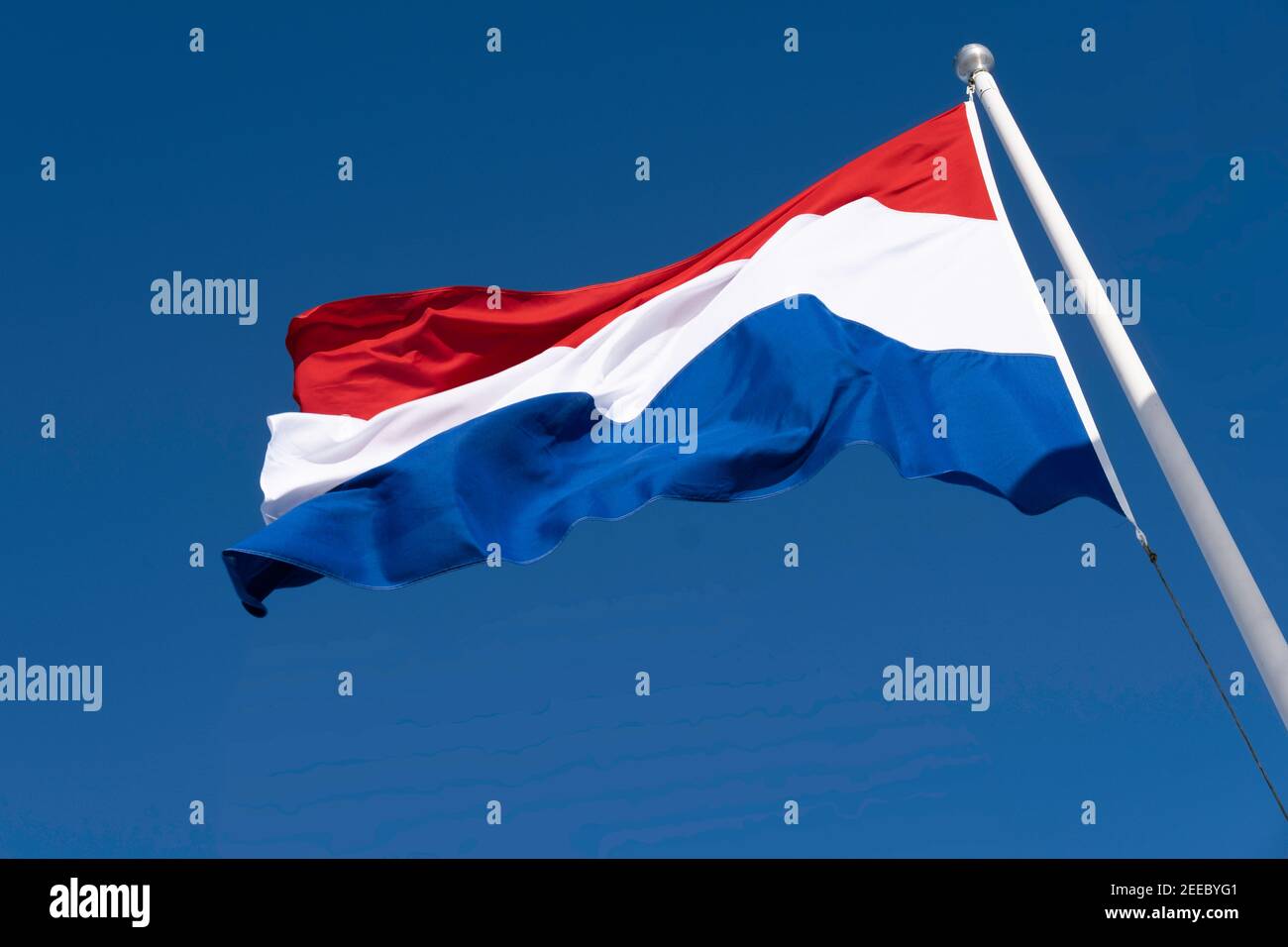 Dutch flag, the tricolor with red, white and blue stripes, flutters ...