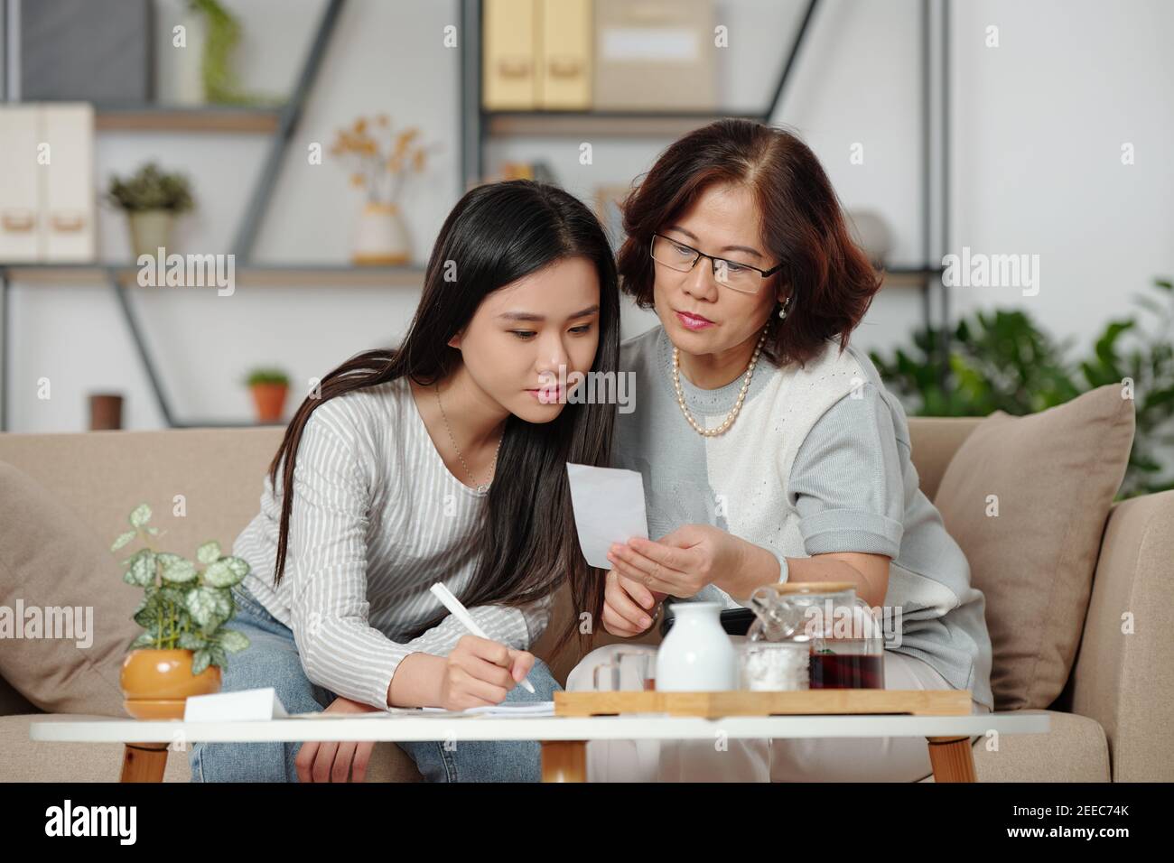 Smiling mother helping young hi-res stock photography and images - Alamy