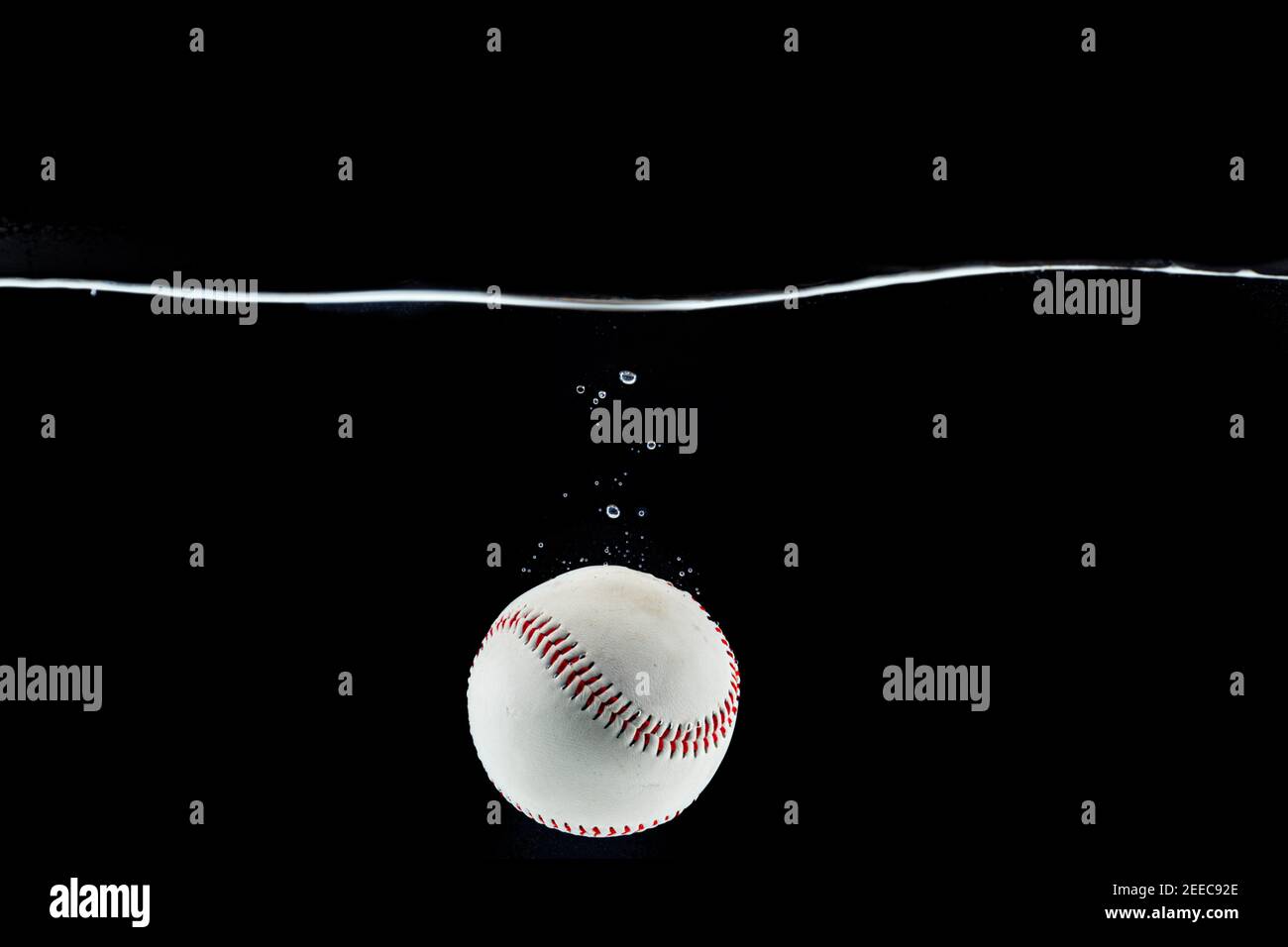 Baseball ball floating in the water against black background Stock ...