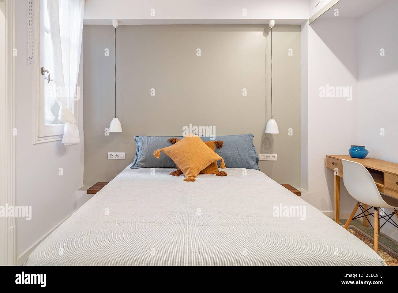 Interior of new bedroom with small table and chair. Bright room with ...