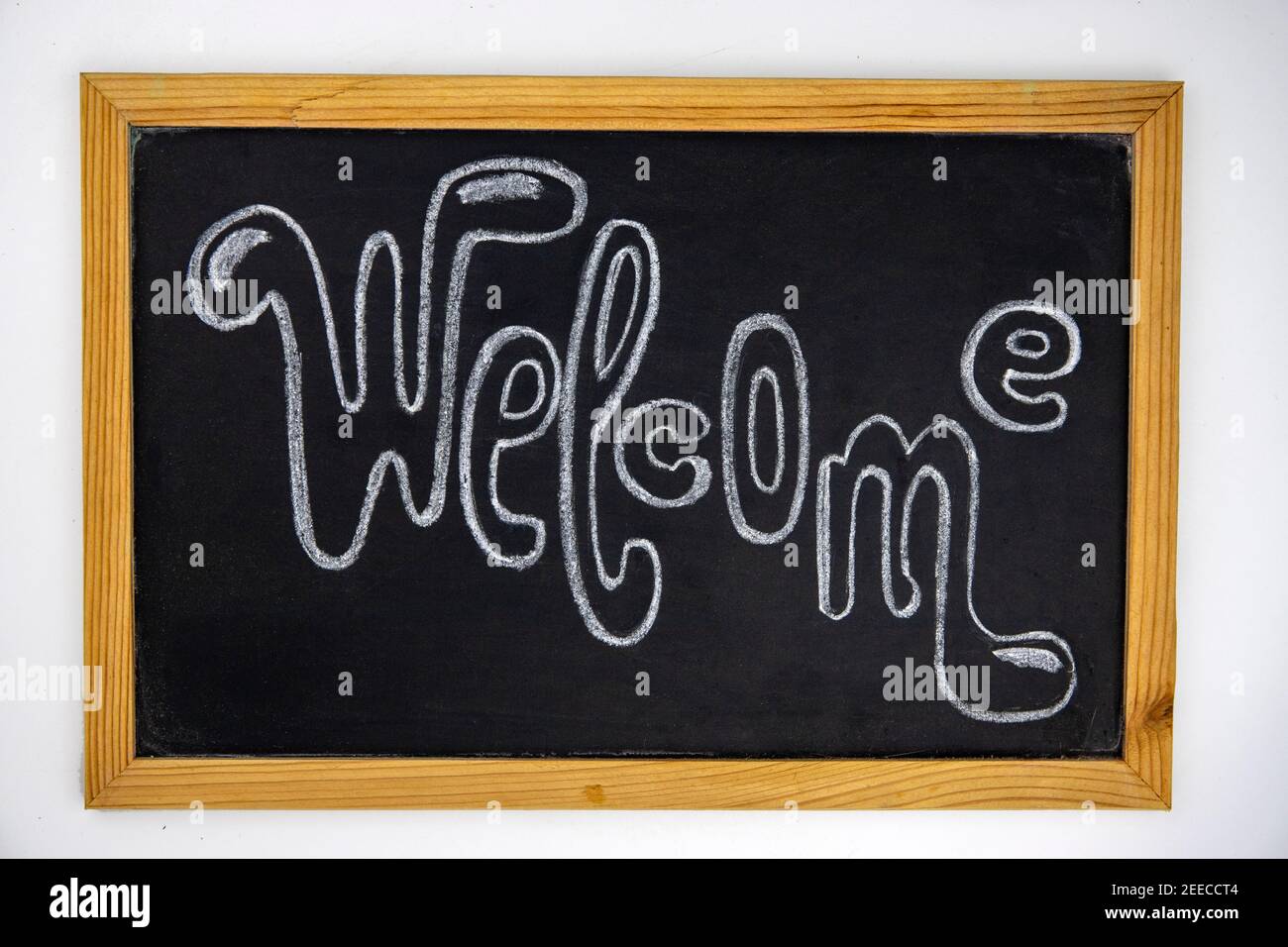 Welcome white chalk lettering inscription on blackboard. School ...