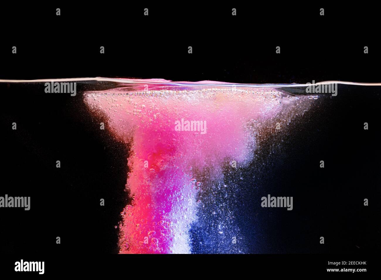 Pink bubbly boiling water against black background Stock Photo - Alamy