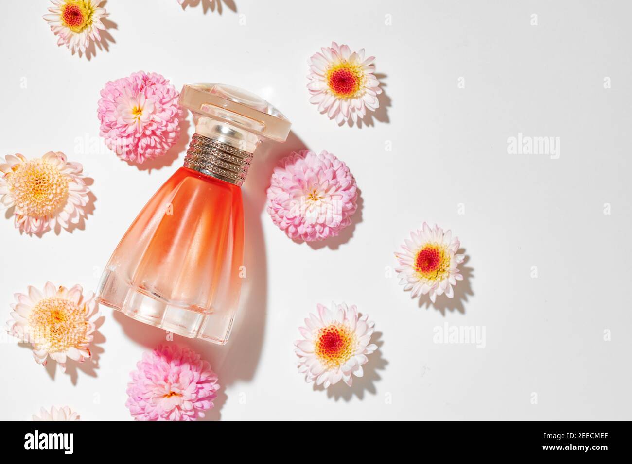 Bottle of fragrance surrounded by flower buds Stock Photo - Alamy