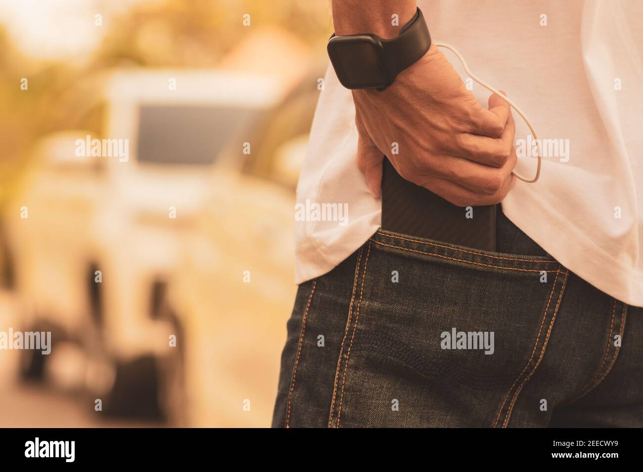 Hand holding the phone in a trouser pocket Stock Photo - Alamy