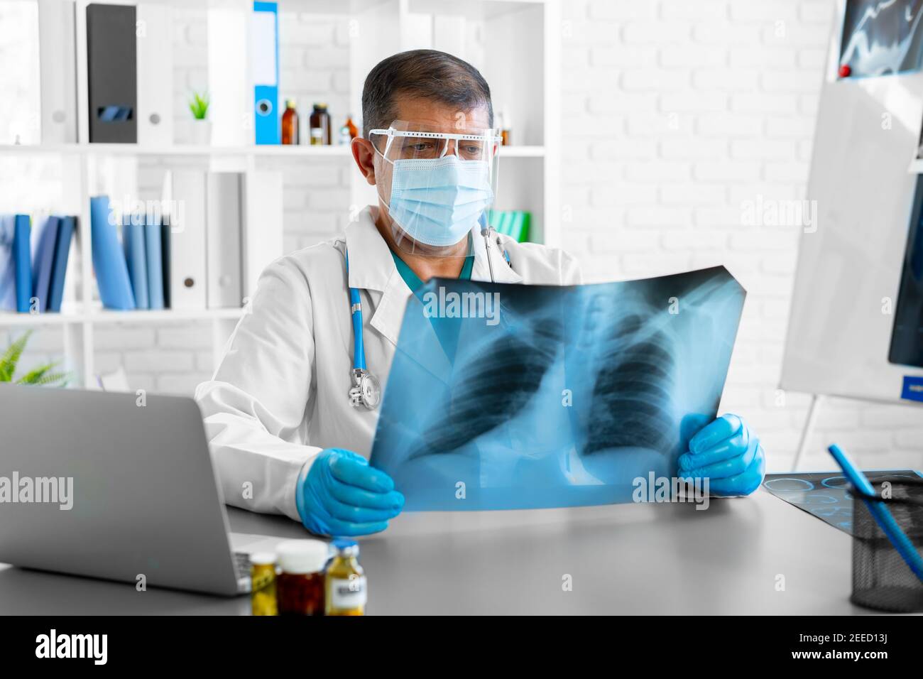 Doctor examining lungs x-ray scan in his office in hospital Stock Photo ...