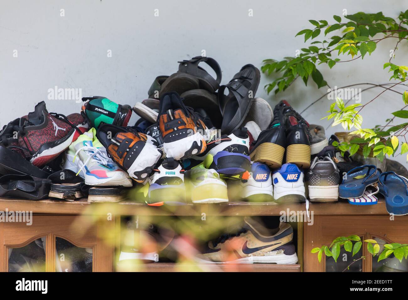 Messy collection view of nike Jordan shoes stack up high on a cupboard ...