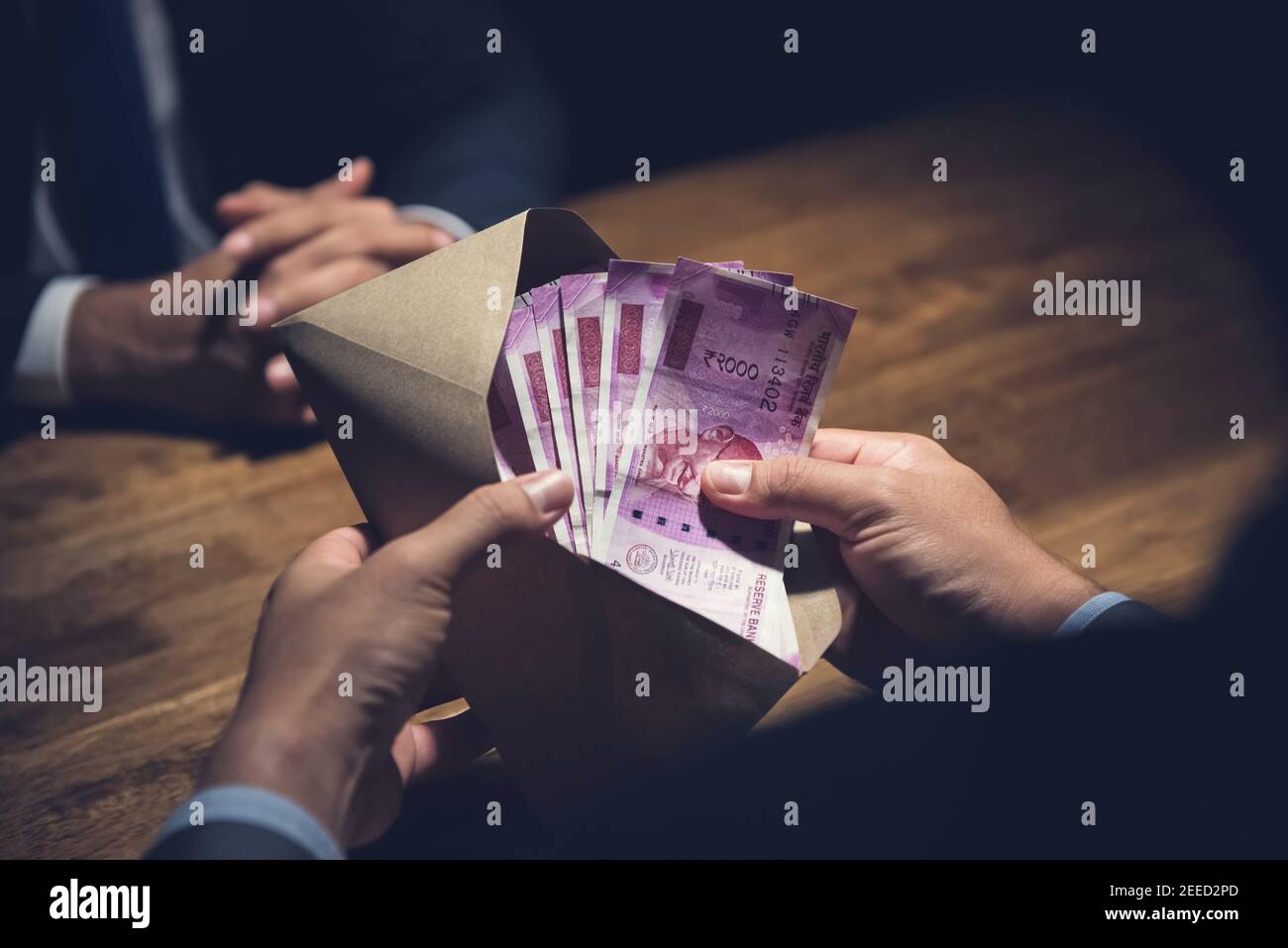 Businessman counting money, Indian Rupee currency, in the envelope just ...