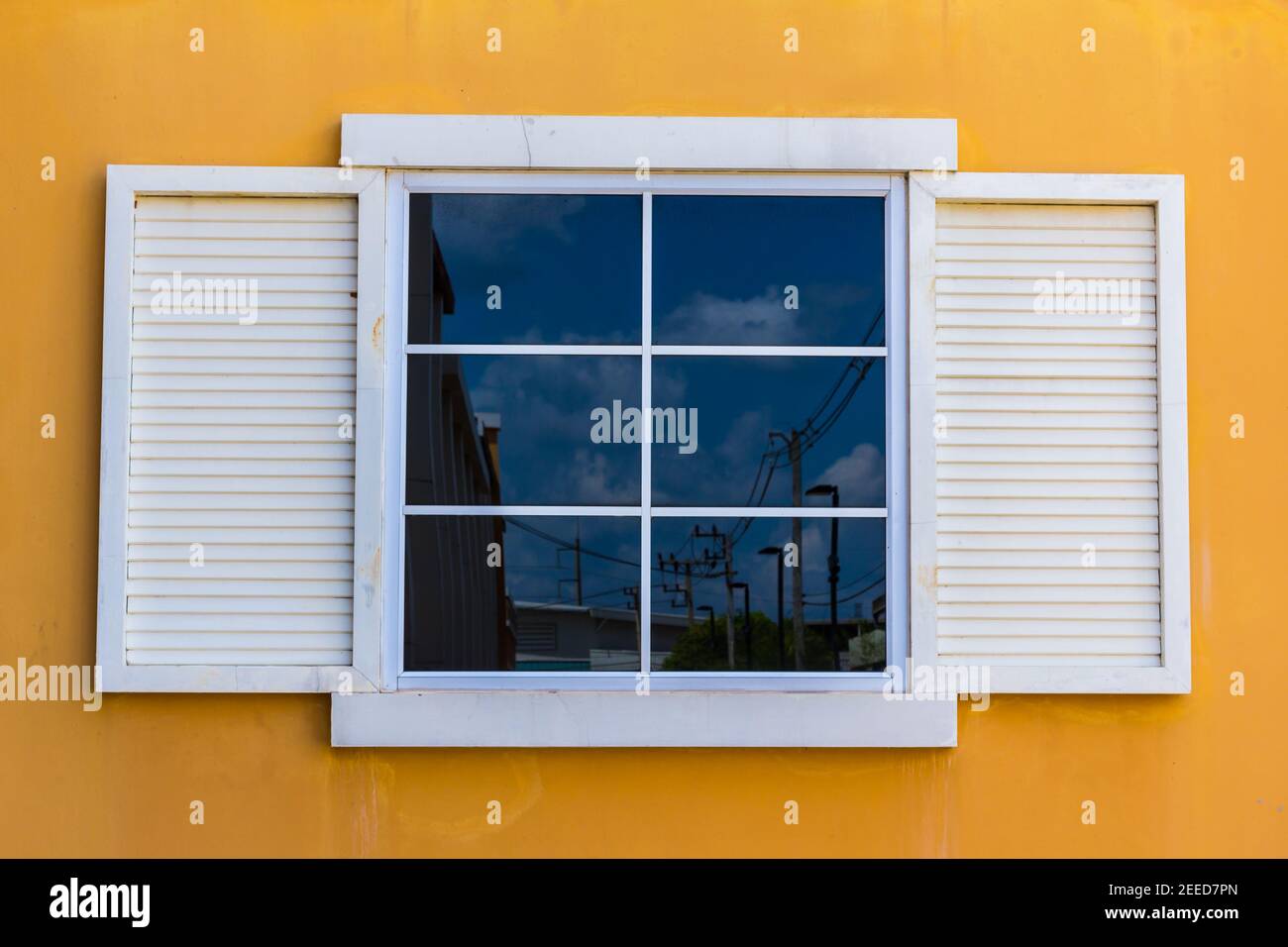 White windows and yellow color wall background Stock Photo - Alamy
