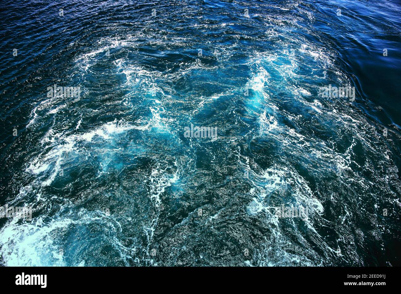 Deep blue seawater texture. Motorboat trail on blue ocean surface ...