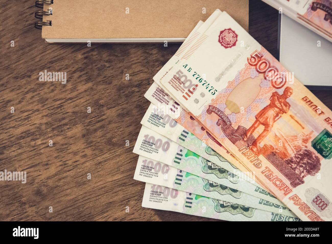 Russian Ruble (RUB )money banknotes on a wooden desk with a notebook ...